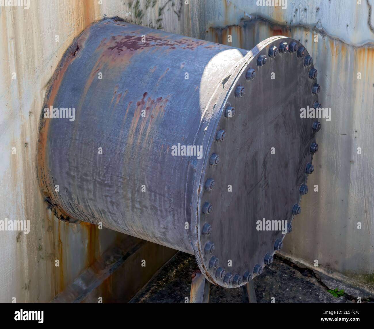 Heavy, metal stop plate, at the end of a massive, sewage plant pipeline ...
