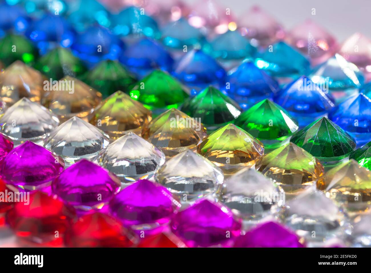 Colorful diamonds are arranged neatly in a row on a white floor Stock ...