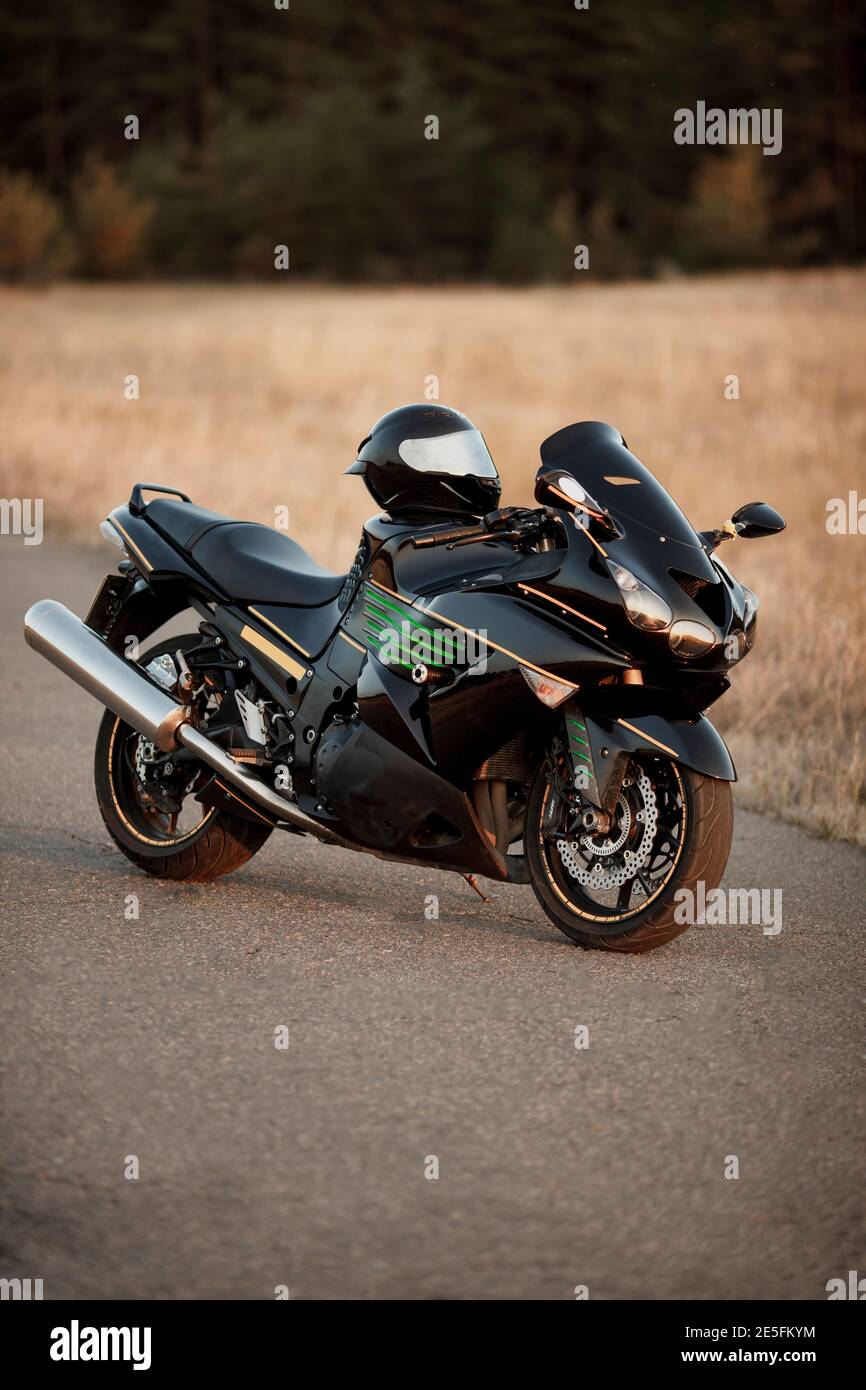 Sports motorcycle and safety helmet on it on the road with beautiful ...