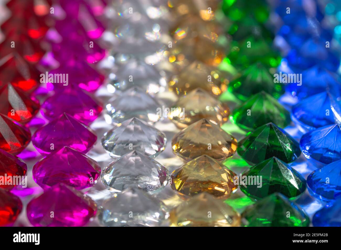 Colorful diamonds are arranged neatly in a row on a white floor Stock ...