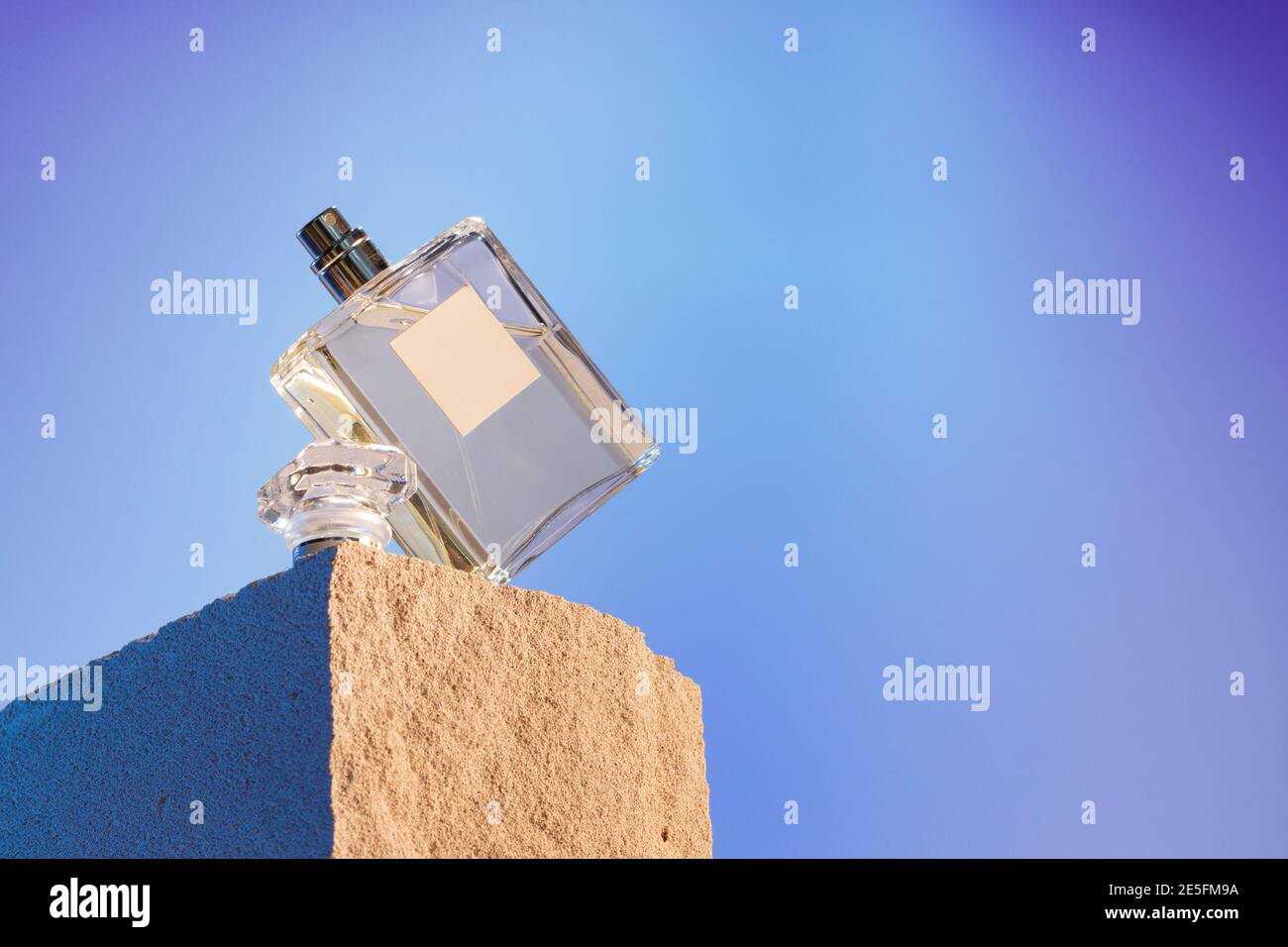 Transparent fragrance bottle on gray .cinder block Stock Photo - Alamy