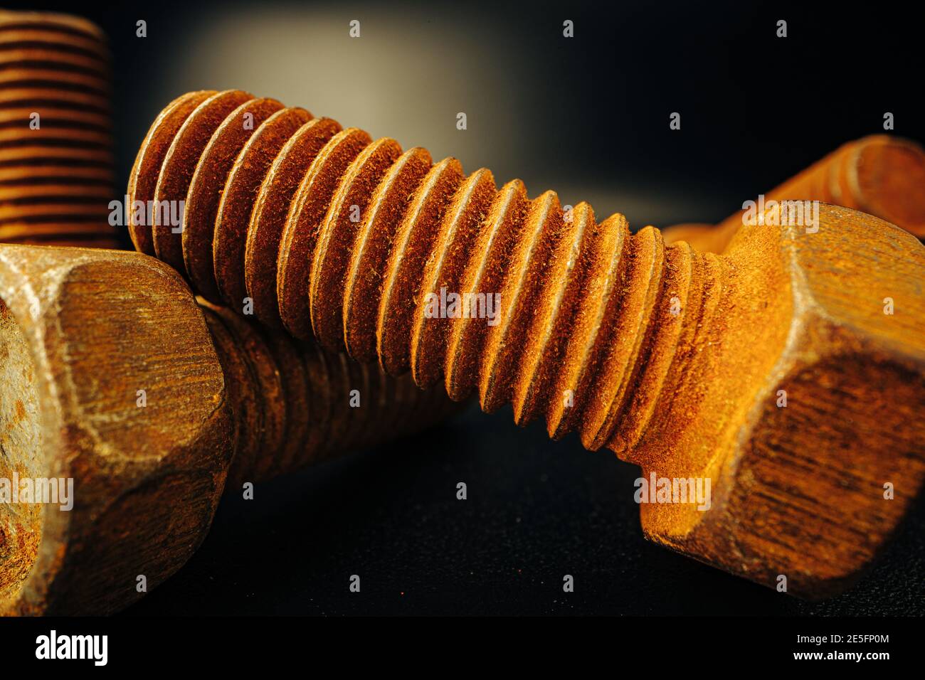 Old rusty bolt on grey background macro Stock Photo - Alamy