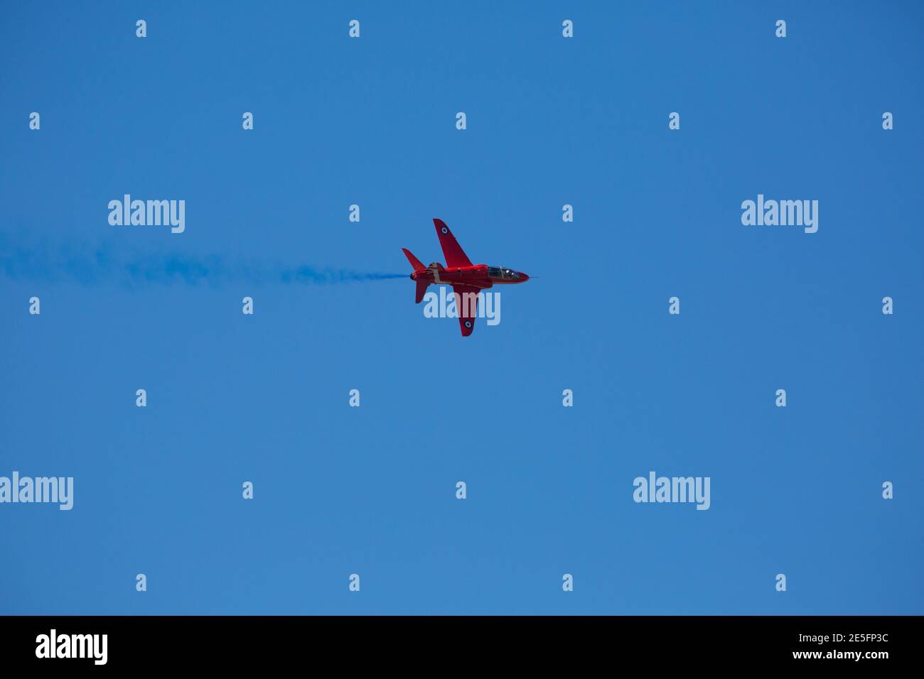 Single Red Arrows jet plane smoke and clear blue sky Stock Photo - Alamy