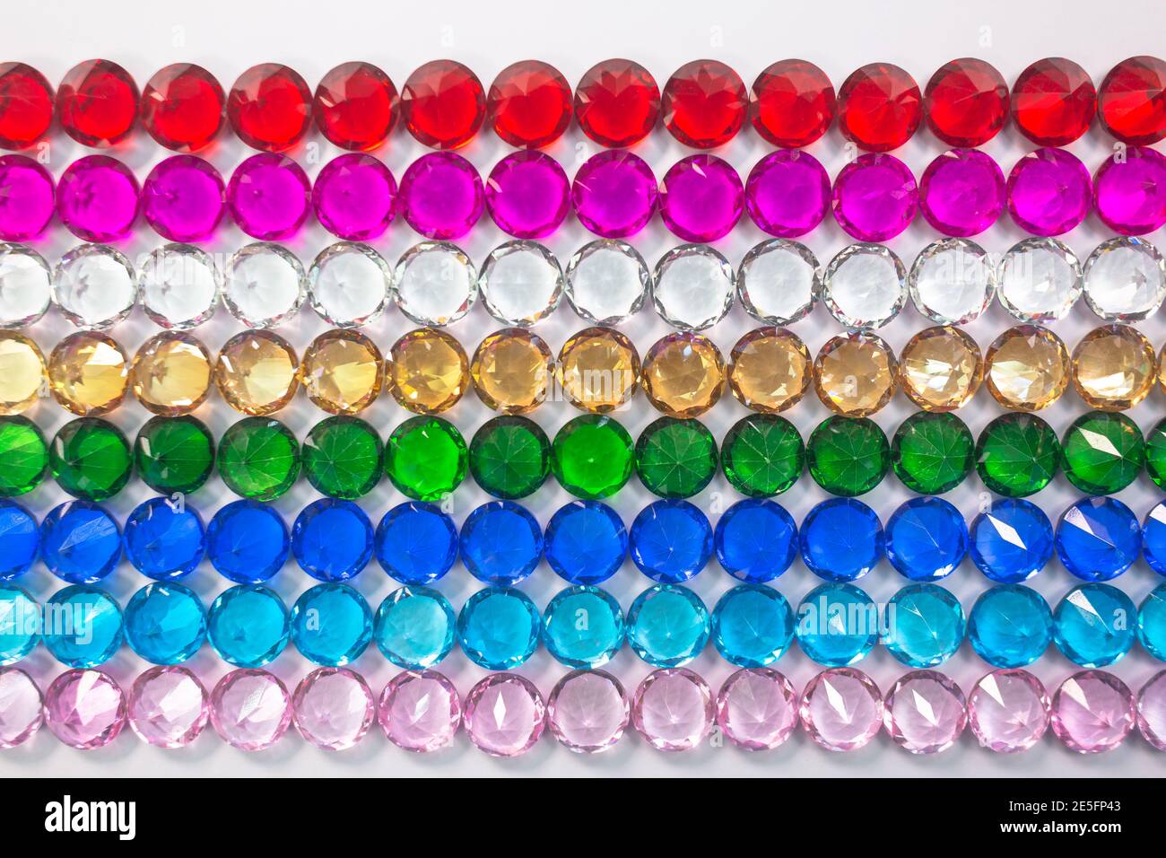 Colorful diamonds are arranged neatly in a row on a white floor Stock ...