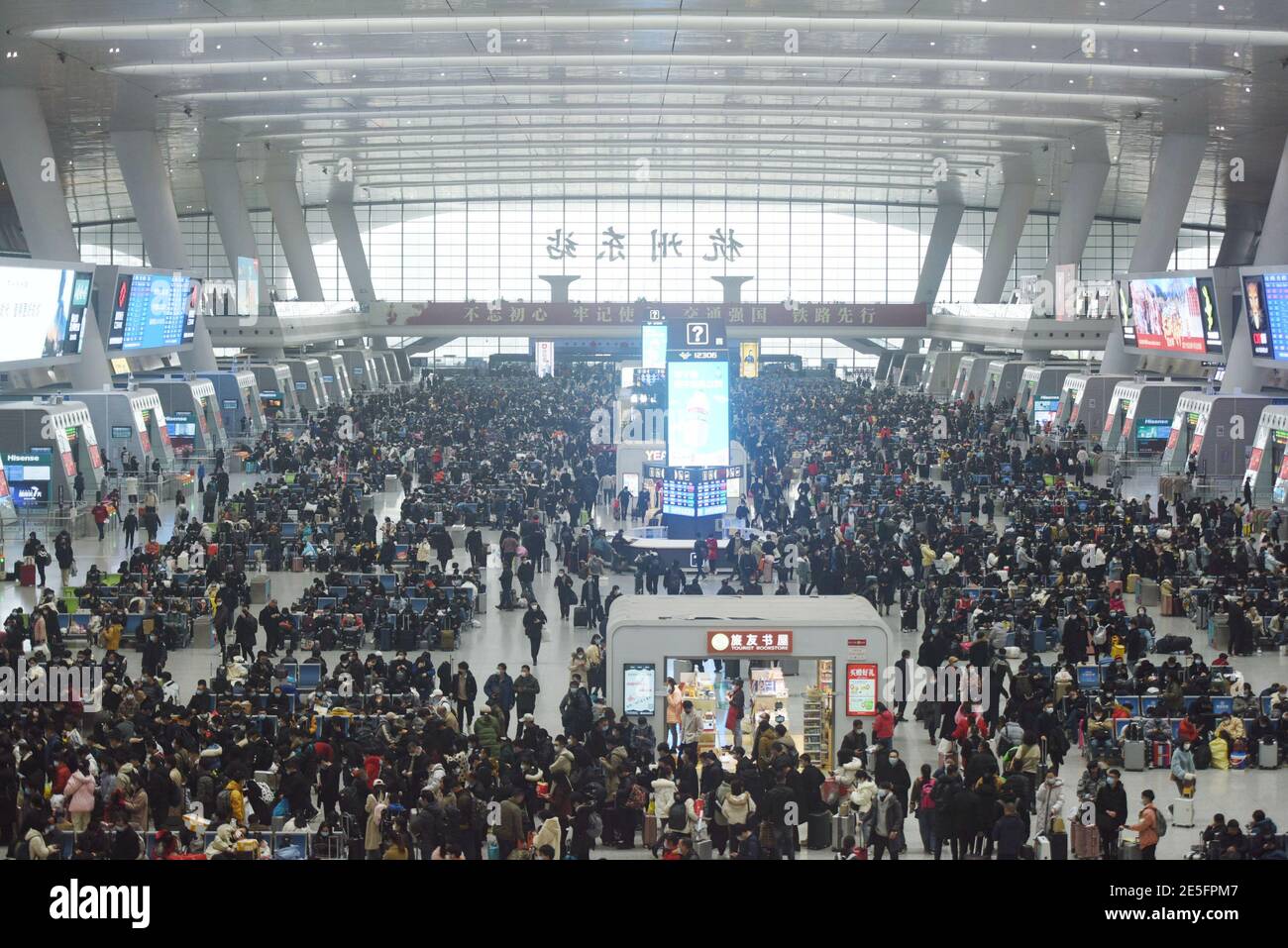 Passengers queue up to get onboard trains on the first day of 2021 ...