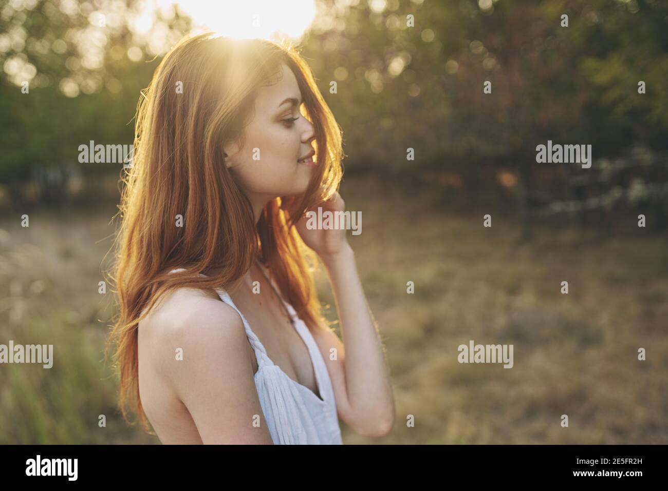 attractive woman outdoors in the garden sunset fresh air trees Stock Photo - Alamy