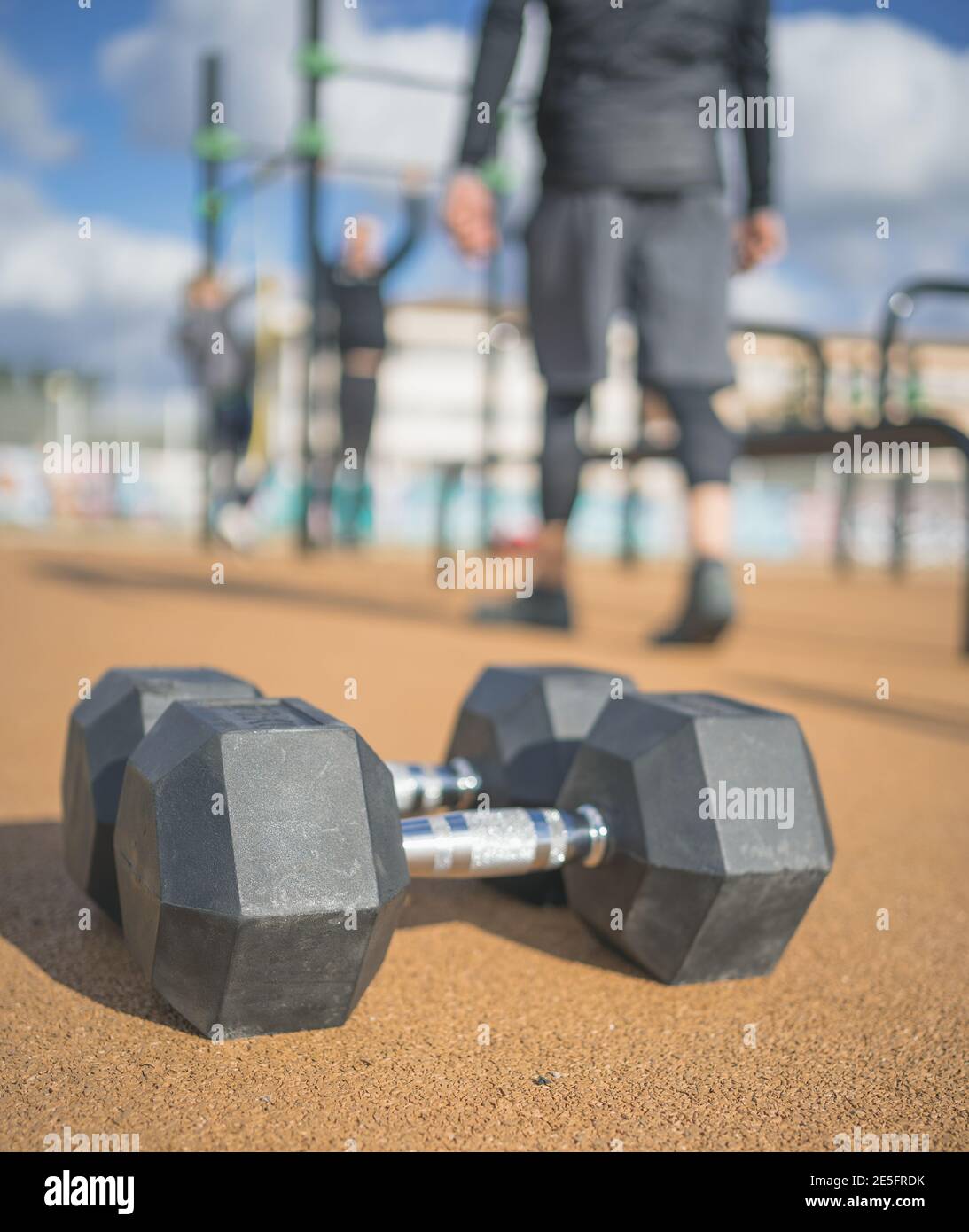 dumbbells on the park floor after exercise sport Stock Photo - Alamy