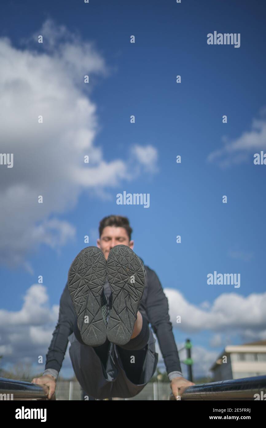 athletic man doing calisthenics in an outdoor park Stock Photo - Alamy