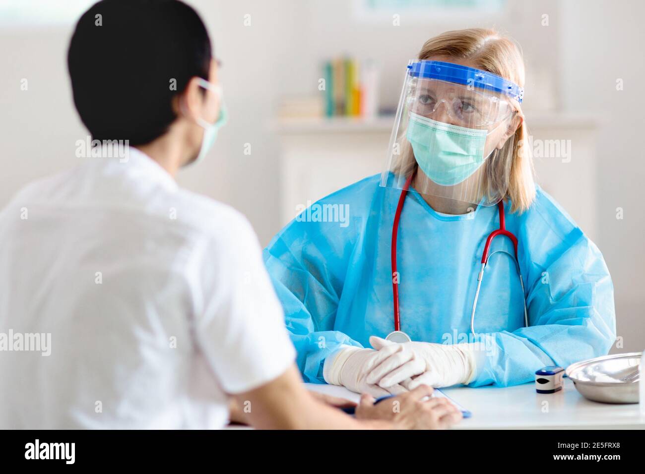 Doctor examining sick patient for coronavirus. Ill Asian man in face ...