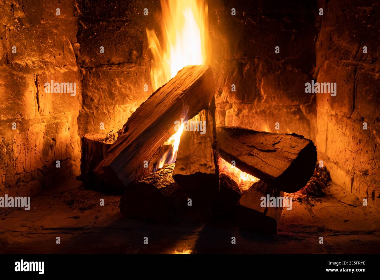A fire burns in a fireplace, Fire to keep warm Stock Photo - Alamy