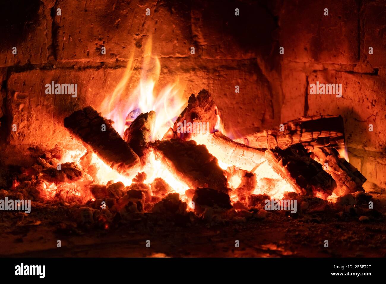 Fire burns in brick fireplace hi-res stock photography and images - Alamy