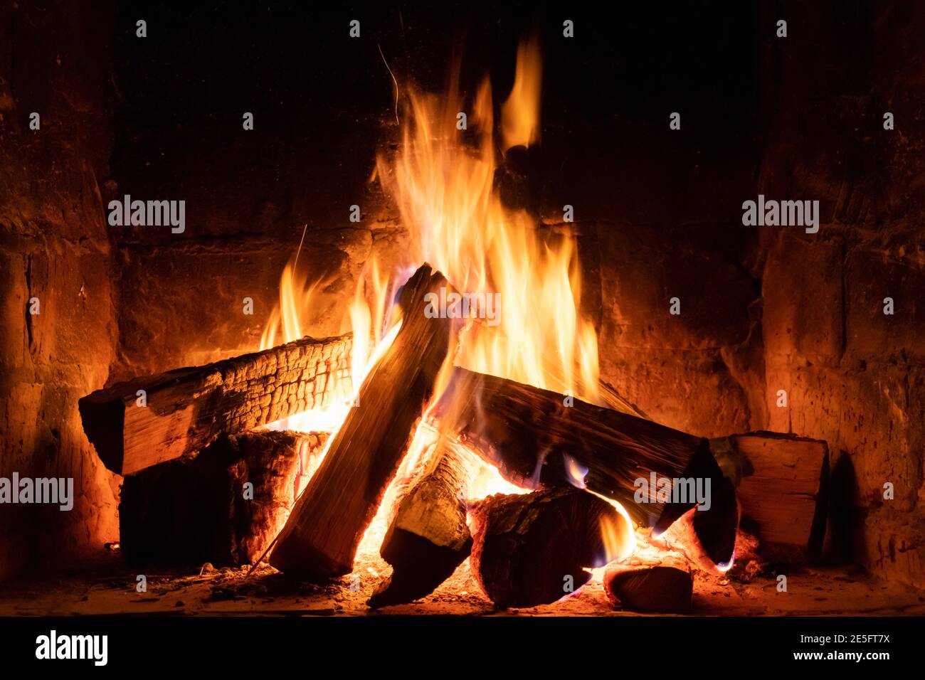 A fire burns in a fireplace, Fire to keep warm Stock Photo - Alamy