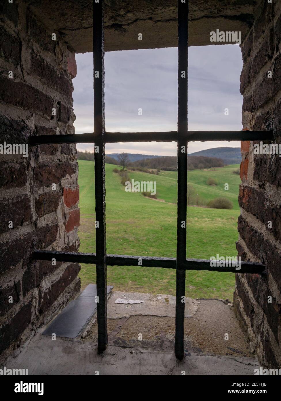 A view of the landscape through the barred window Stock Photo - Alamy