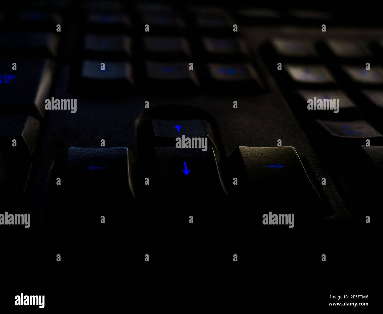 Direction keys on the keyboard backlit in blue in the dark Stock Photo ...
