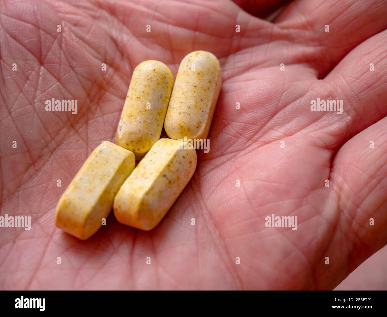 Herbal pills in the palm of hand Stock Photo - Alamy