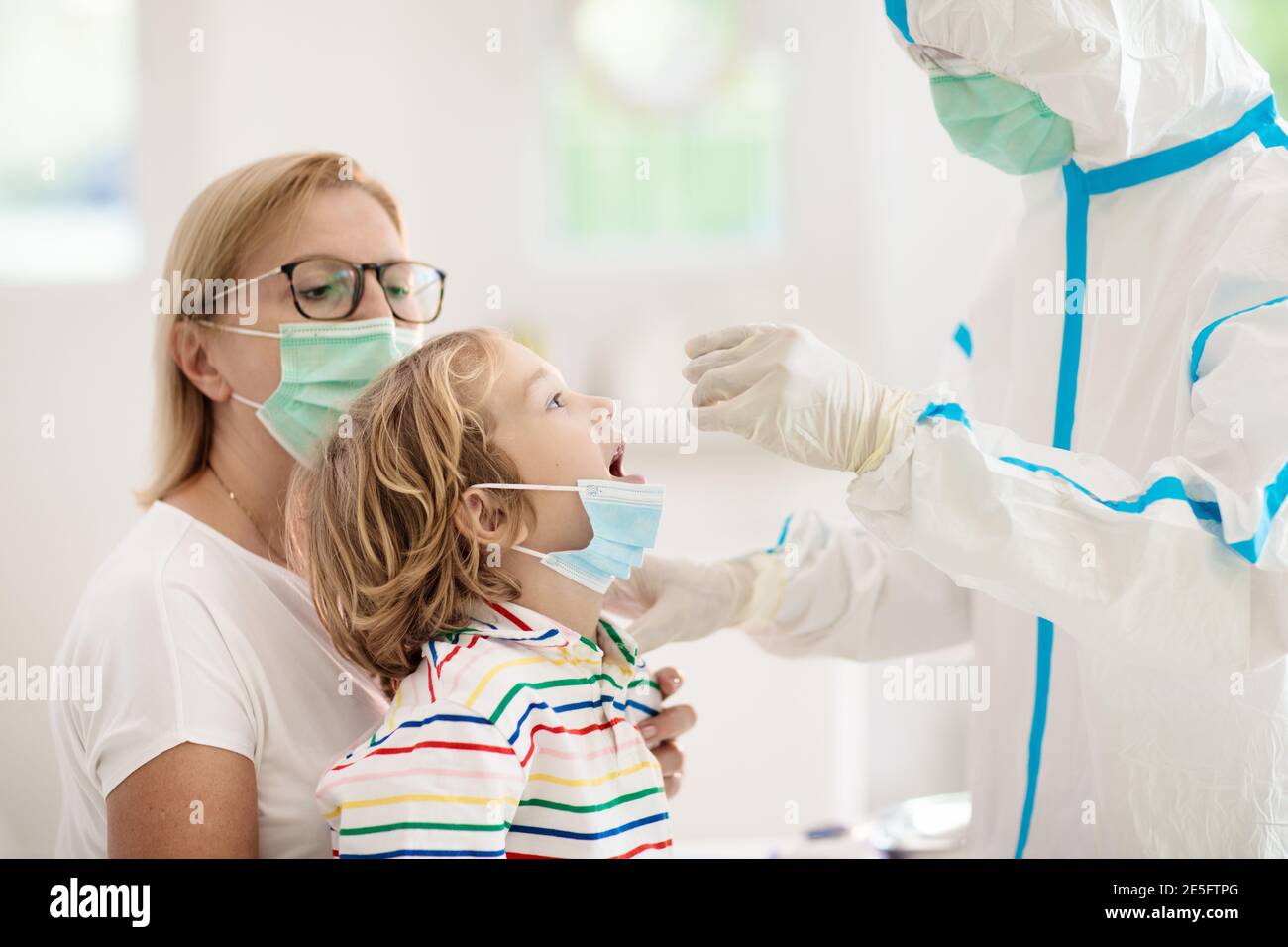 Coronavirus nasal swab test for kids. Doctor taking saliva sample for ...