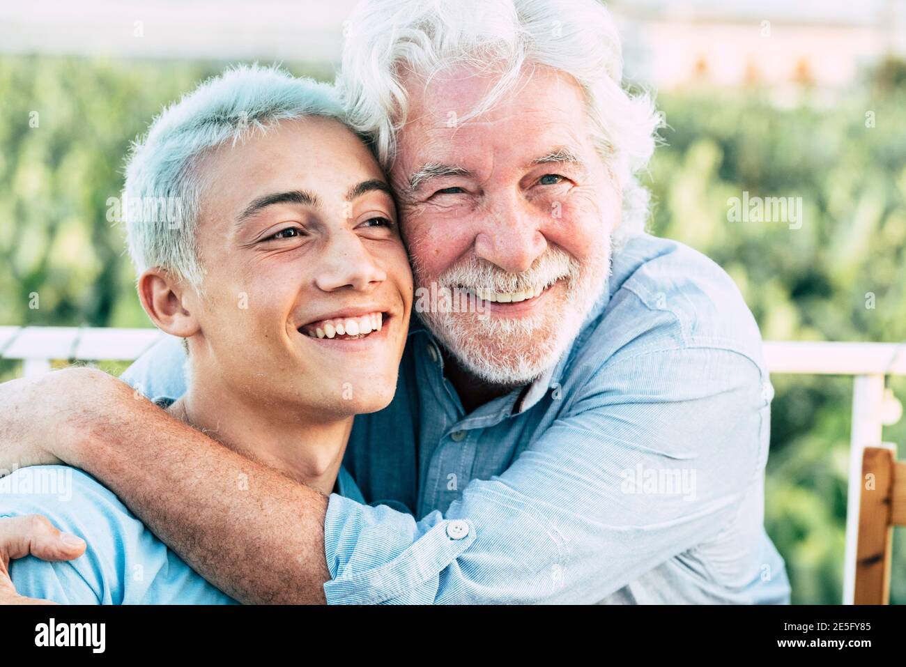Father and son or grandfather and grandson together hug and enjoy with ...