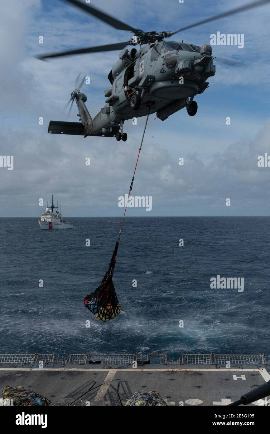 MH-60R Seahawk from HSM-37 transfers contraband to USS Halsey DDG-97 ...
