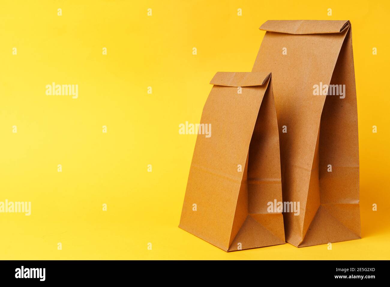 Craft packets on bright yellow paper background Stock Photo - Alamy