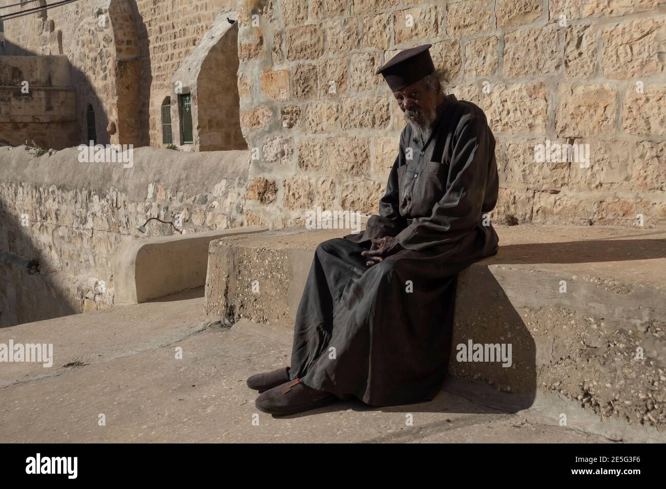 An Ethiopian Orthodox monk sitting at the roof of Deir El-Sultan ...