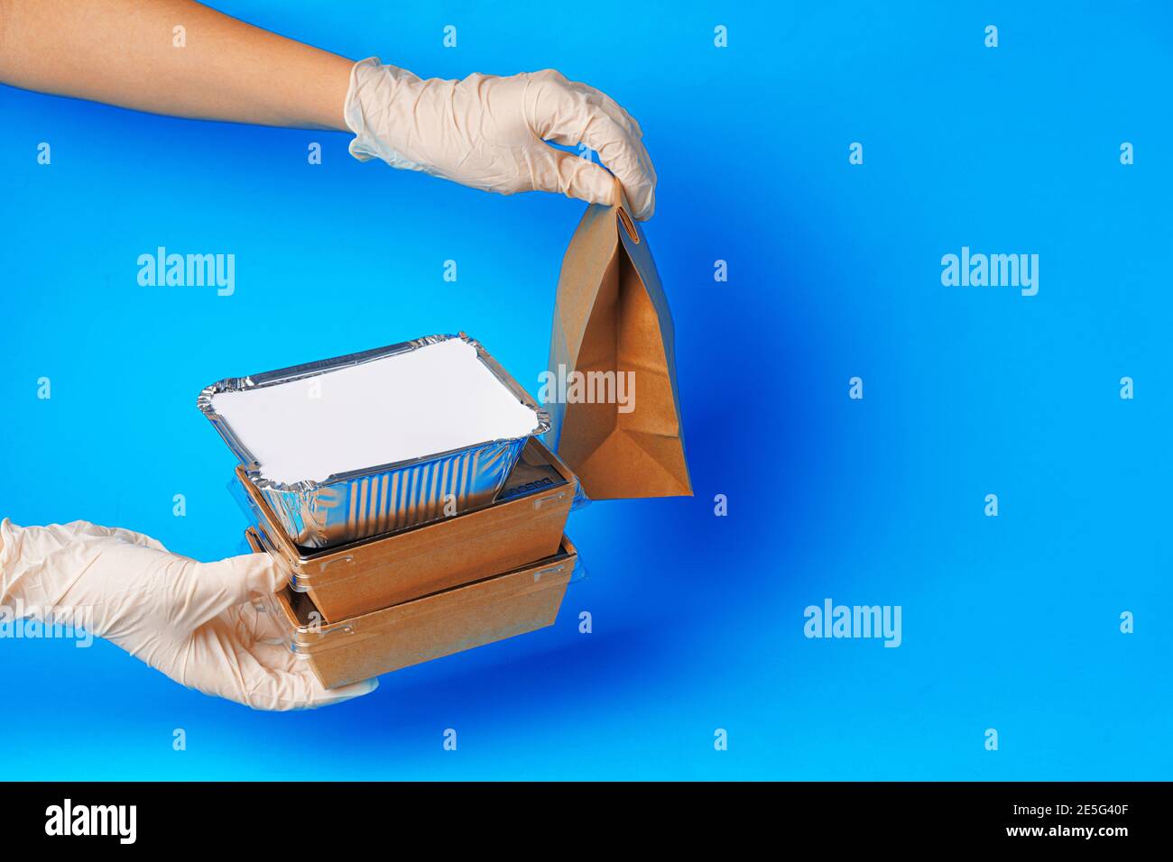 Delivery man hands giving food containers and packages Stock Photo - Alamy