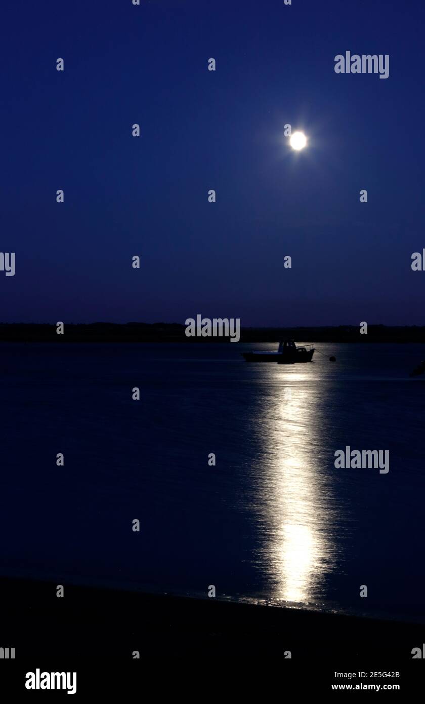 Fishing boat lit up by the moon at Wells Salt Marshes, Wells-Next-The ...