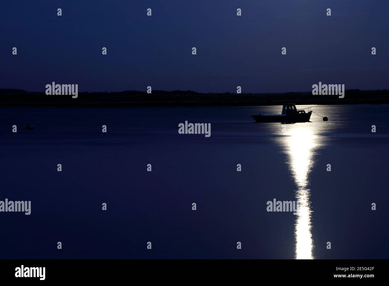 Fishing boat lit up by the moon at Wells Salt Marshes, Wells-Next-The ...