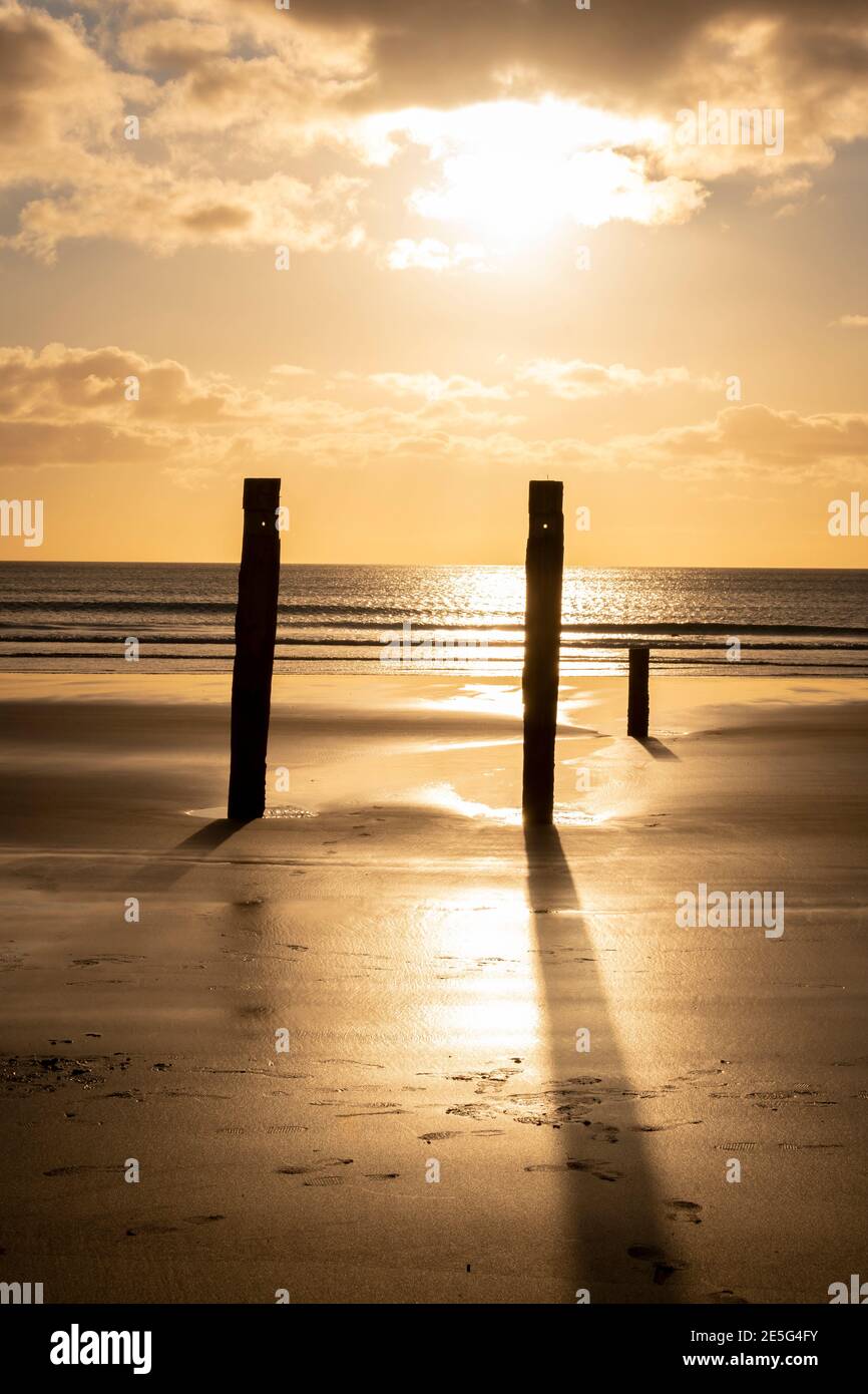 Remains of old wharf on beach at Akitio, Tararua District, North Island ...