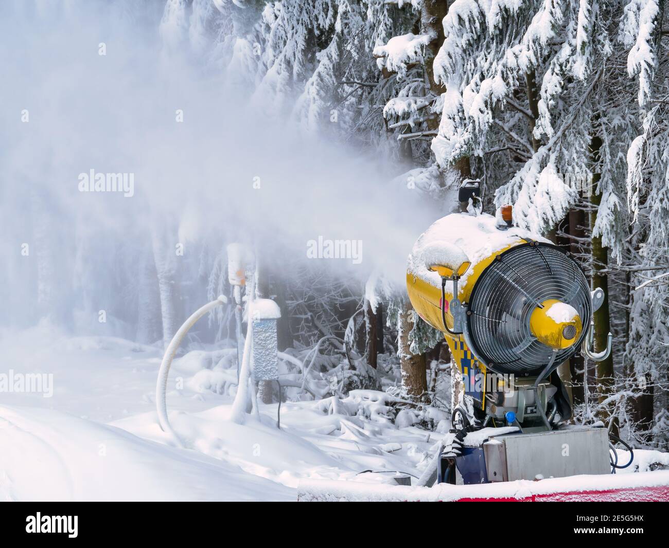 Snow cannon or snow gun throwing snow on the ski slopes in Predeal ...