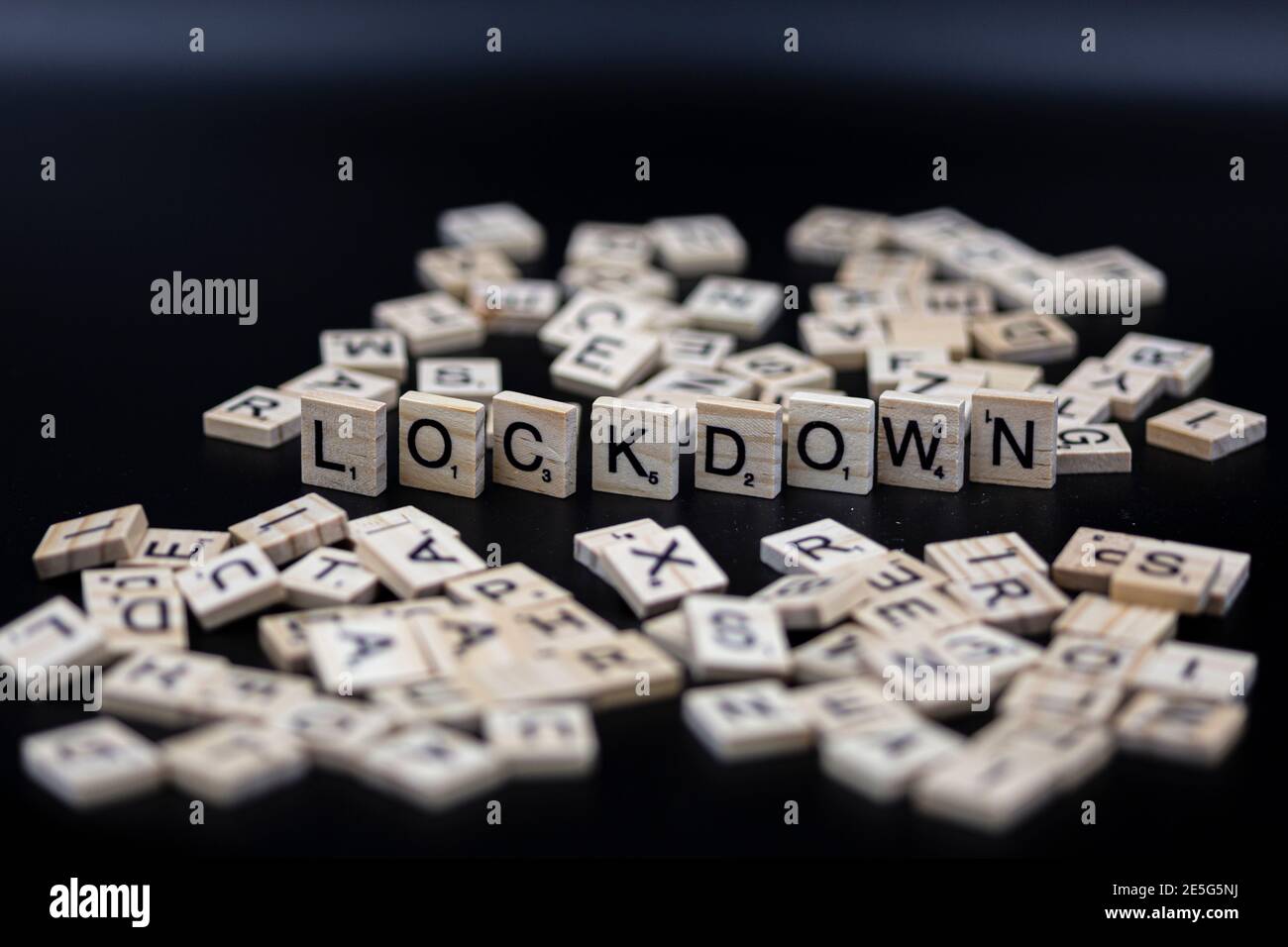 Lock down - Covid-19 - Scrabble letters - dark background Stock Photo ...