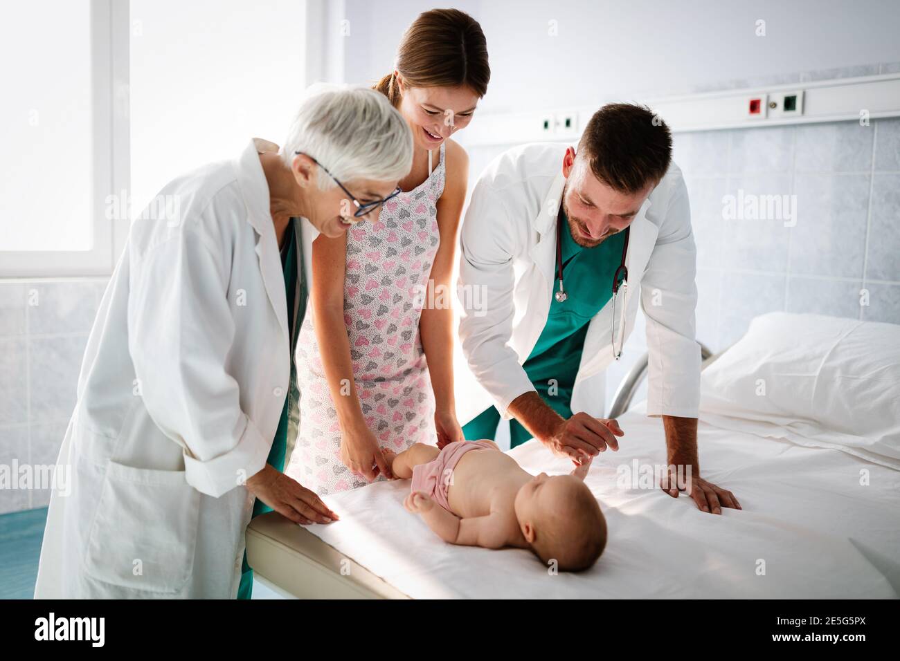 Pediatricians doctors examining little cute baby in hospital Stock ...