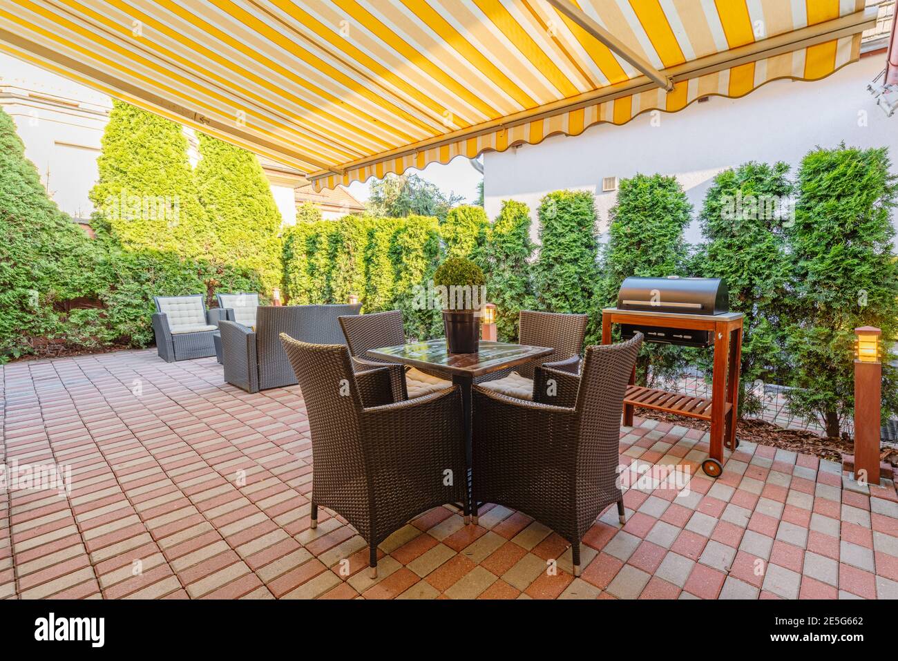 backyard terrace with a table and barbecue Stock Photo - Alamy