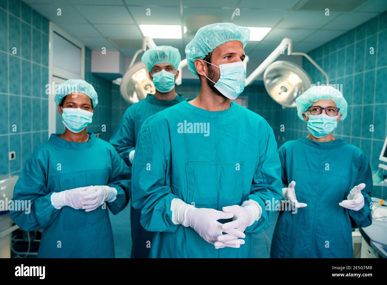 Successful team of surgeon standing in operating room, ready to work on ...