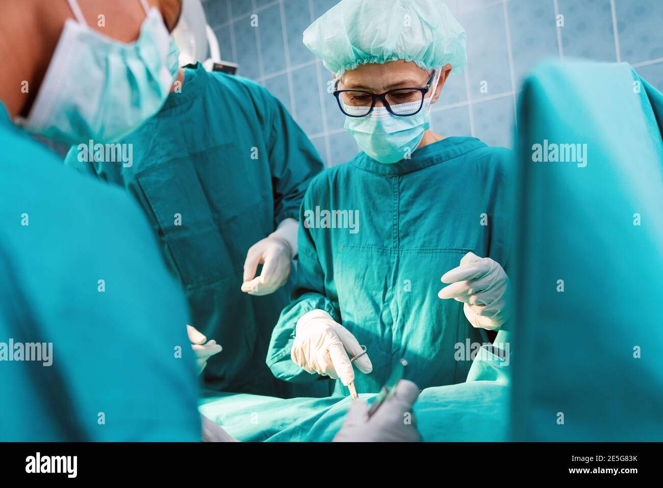 Surgery team operating in a surgical room Stock Photo - Alamy