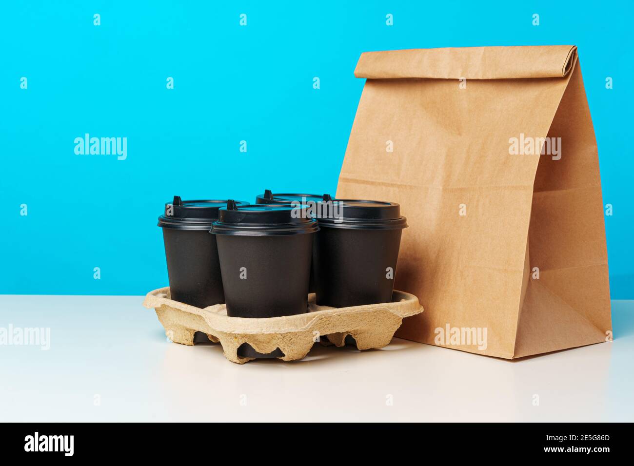 Coffee cups and takeaway food package. Takeout meal Stock Photo - Alamy