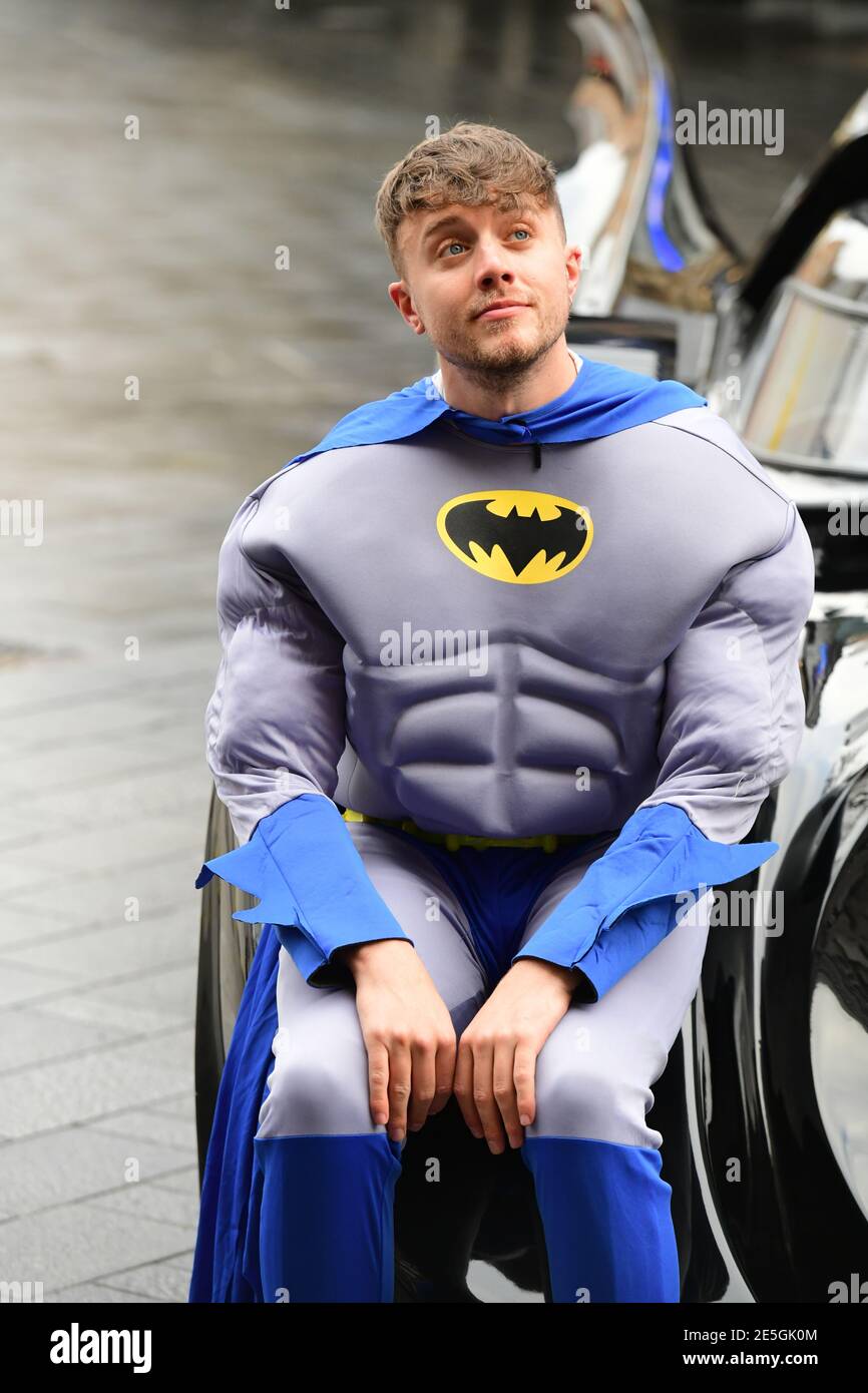 Roman Kemp dressed as Batman posing with the Batmobile outside the ...