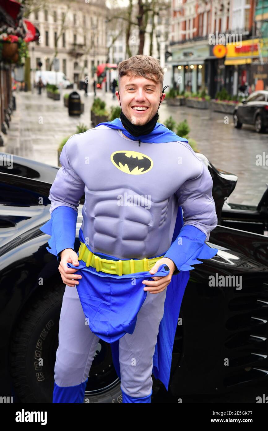 Roman Kemp dressed as Batman posing with the Batmobile outside the ...