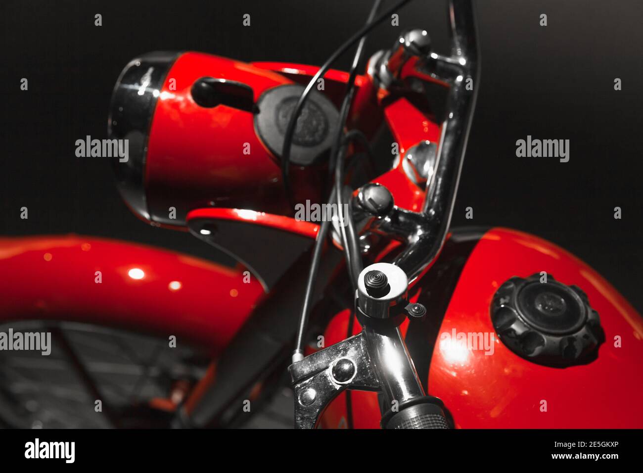 Vintage red motorcycle headlight and handlebar, close-up photo with ...