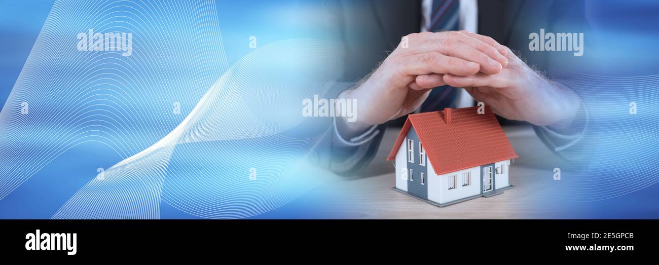 Insurance agent protecting house with his hands; panoramic banner Stock ...