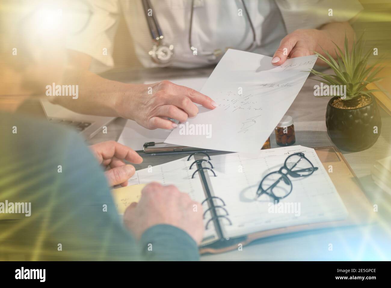 Female doctor giving prescription to her patient in medical office ...
