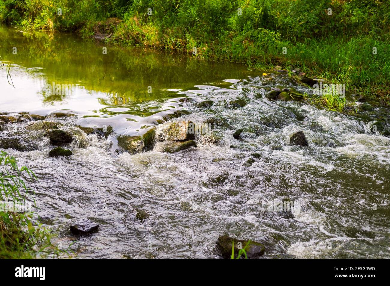 River flow over rocks in summer day. Waves of the river flow. Relaxing ...