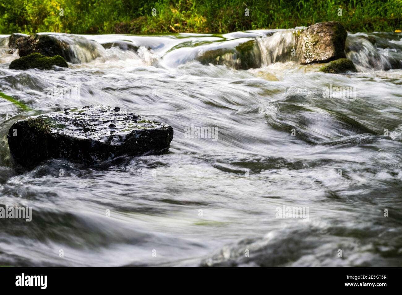 River flow over rocks in summer day. Waves of the river flow. Relaxing ...