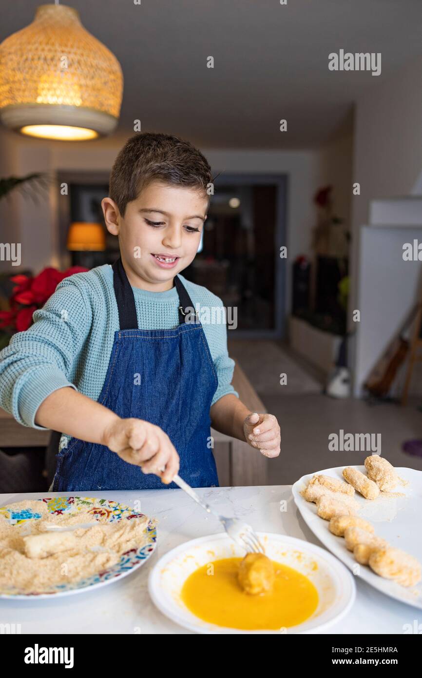 Little boy making croquettes in the kitchen Stock Photo - Alamy