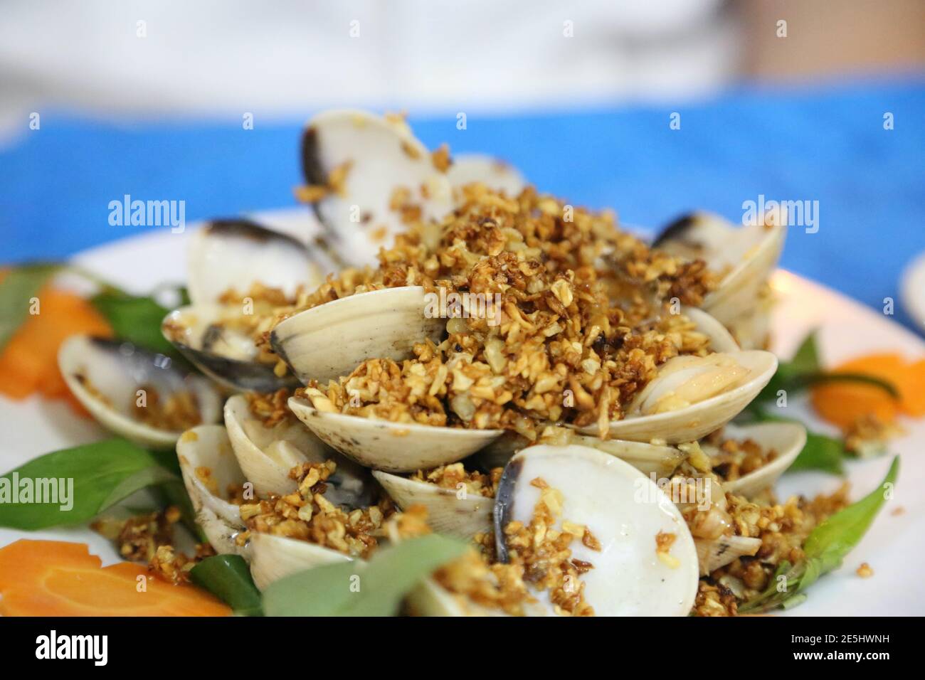 Stir-fried white clams with crispy garlic, Vietnamese style Stock Photo ...