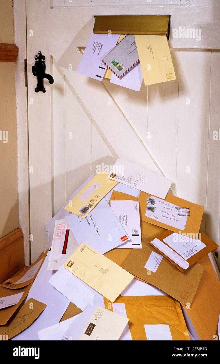 enormous pile of junk mail through letterbox Stock Photo - Alamy
