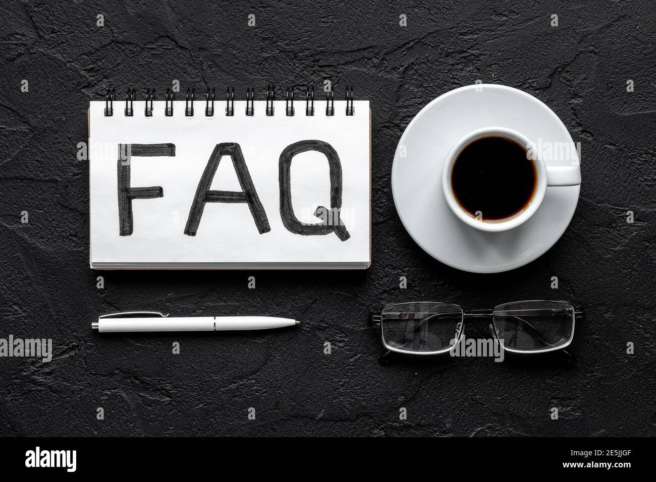FAQ Question concept. Text on office dest, top view Stock Photo - Alamy