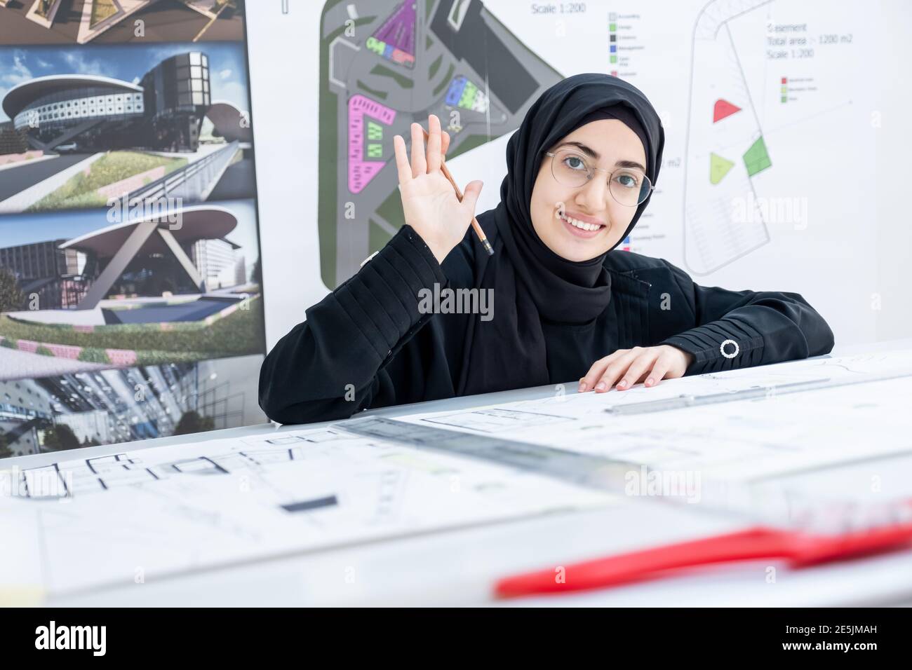 Arab female architect greeting while working in her office Stock Photo ...