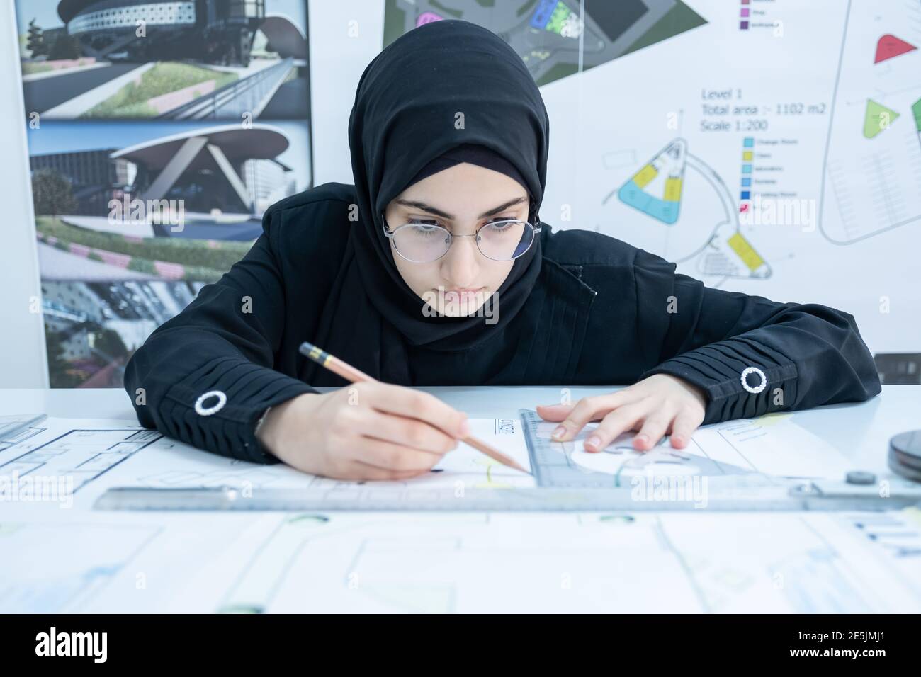 Female architect working on new project and making sketches Stock Photo ...