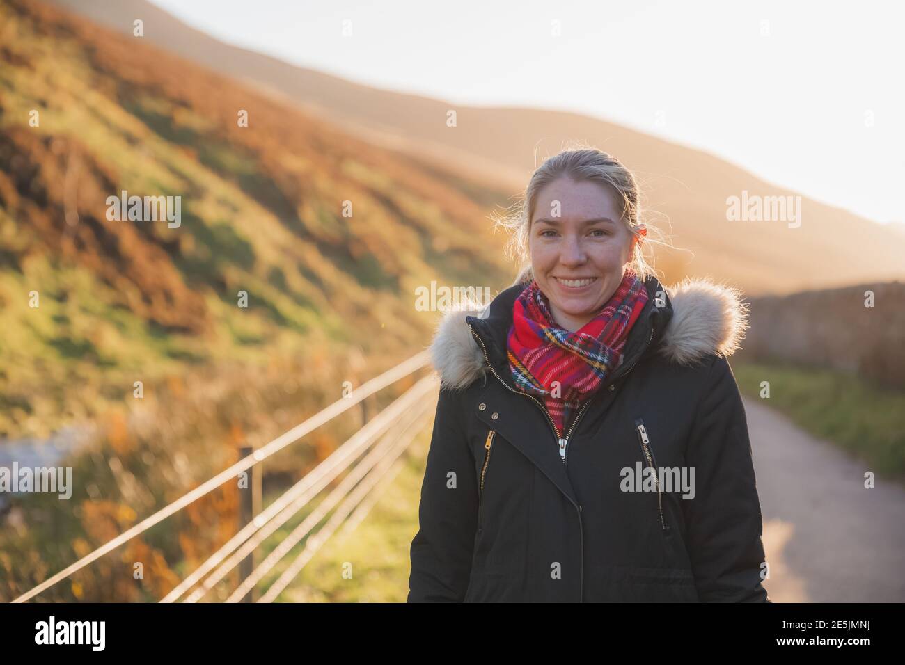 Smiling young woman on country road hi-res stock photography and images ...