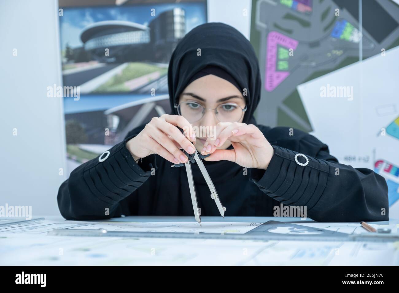 Female arab architect using compass Stock Photo - Alamy